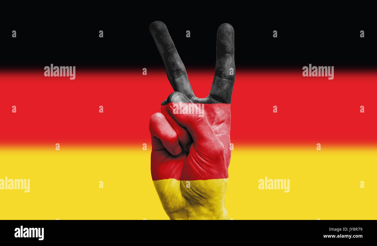 Germany national flag painted onto a male hand showing a victory, peace ...