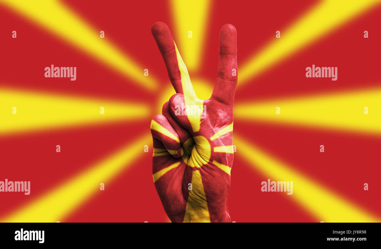 Macedonia national flag painted onto a male hand showing a victory ...