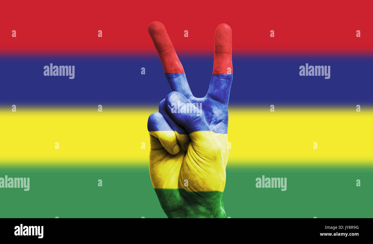 Mauritius national flag painted onto a male hand showing a victory ...