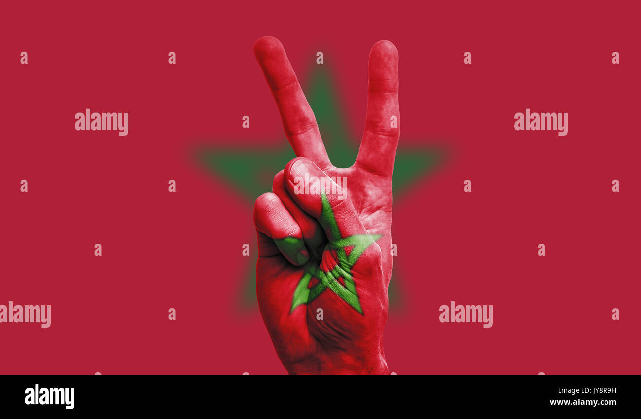 Morocco national flag painted onto a male hand showing a victory, peace ...