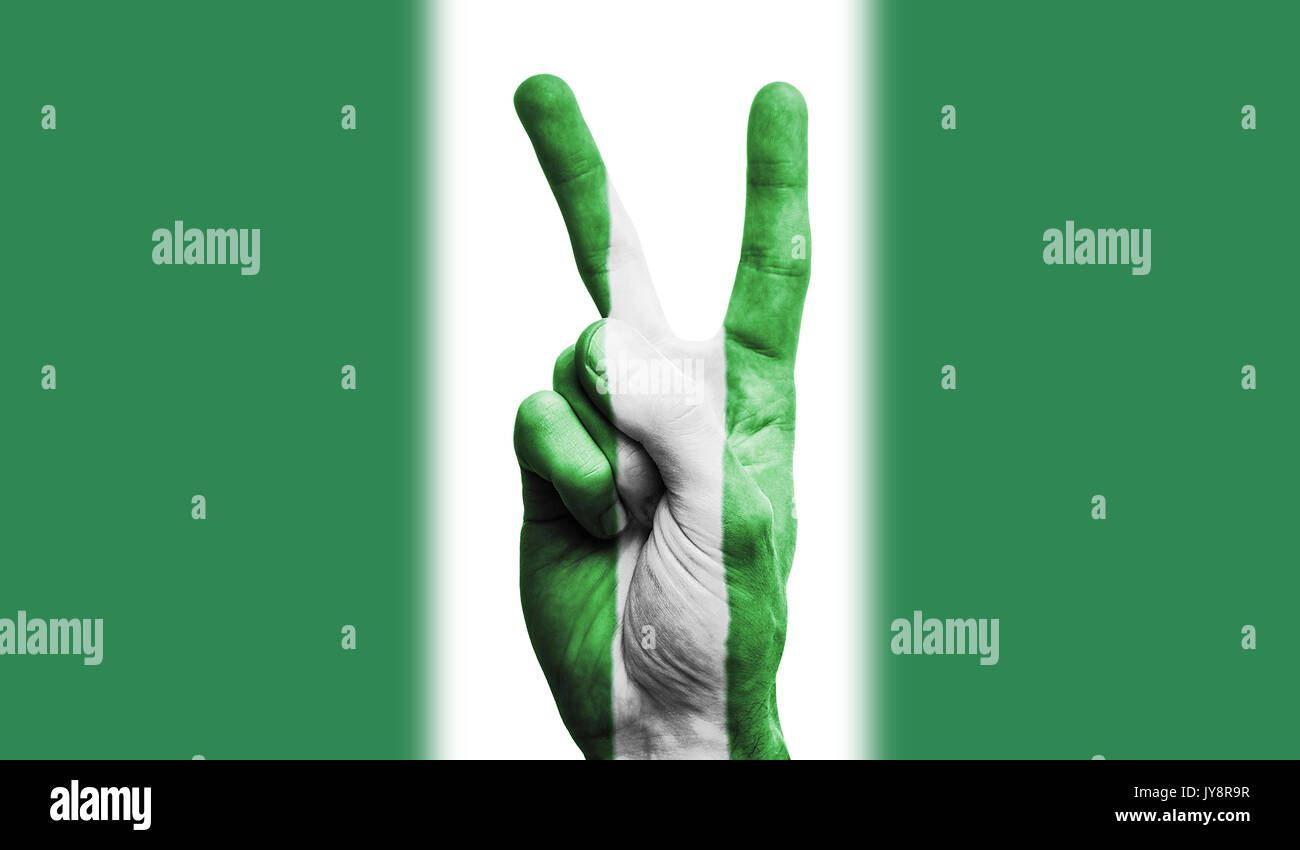 Nigeria national flag painted onto a male hand showing a victory, peace ...