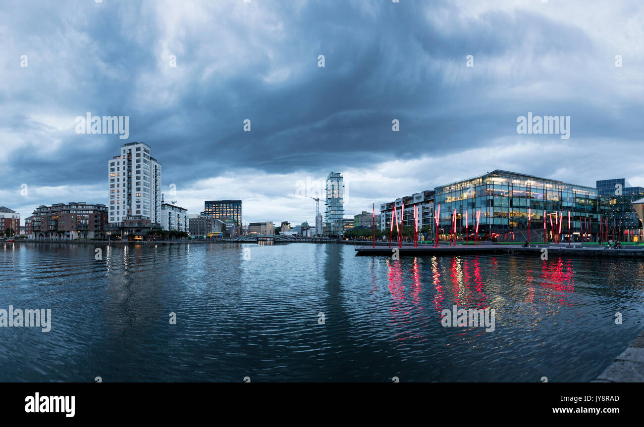 Panorama of Dublin's Grand Canal Dock at night with stormy sky overhead ...