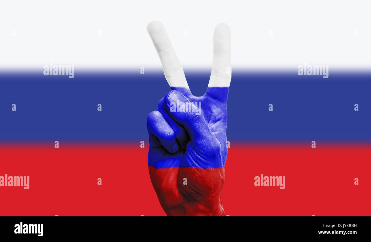 Russia national flag painted onto a male hand showing a victory, peace ...