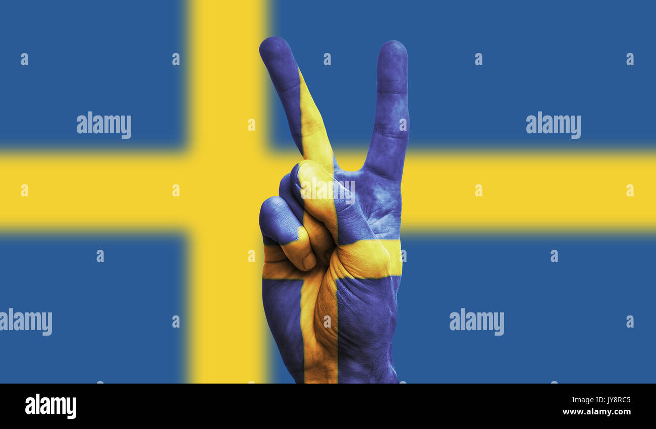 Sweden national flag painted onto a male hand showing a victory, peace ...