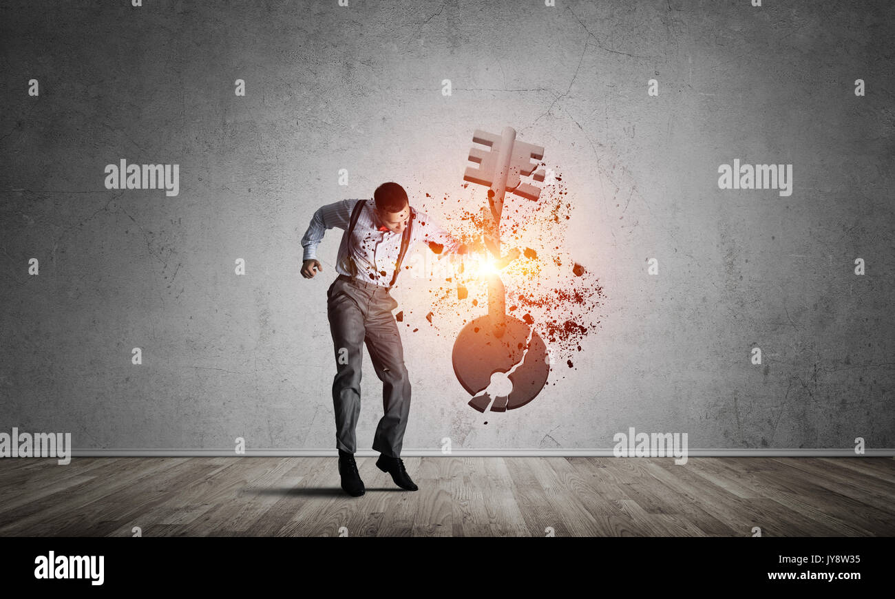 Breaking through access concept with man in room crashing concrete key ...