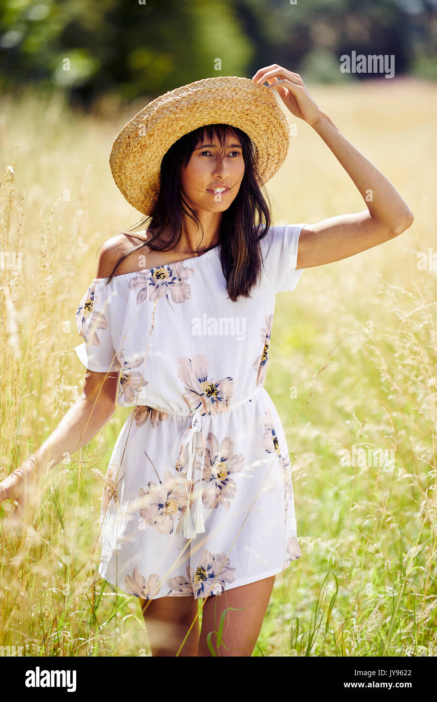 Beautiful girl walking in field Stock Photo - Alamy