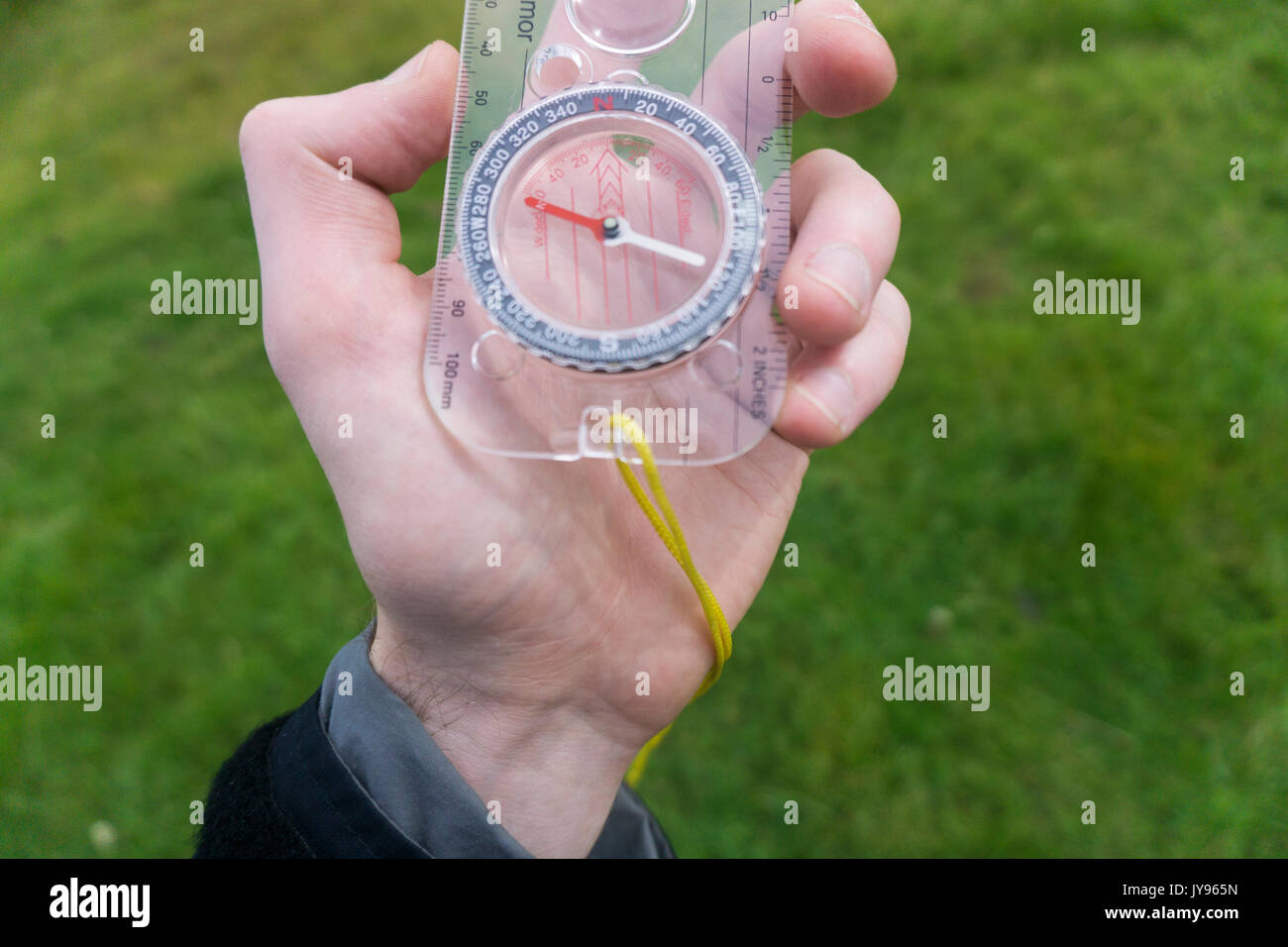 Male explorer with a compass in her hand. Point of view Stock Photo - Alamy