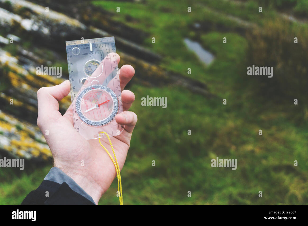 Male explorer with a compass in her hand. Point of view Stock Photo - Alamy