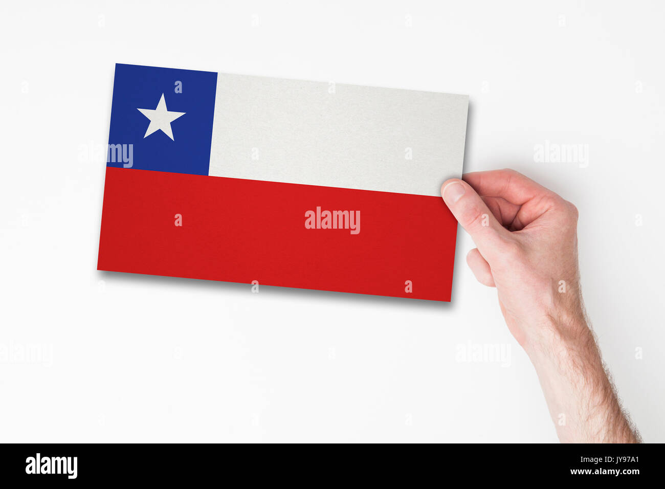 Male hand holding chile flag Stock Photo - Alamy