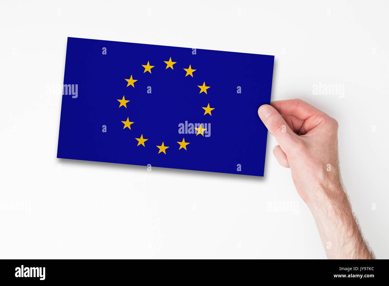 Male hand holding european union flag Stock Photo - Alamy