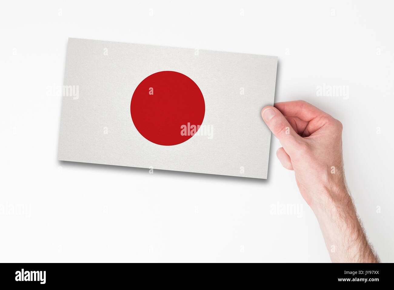 Male hand holding japan flag Stock Photo - Alamy