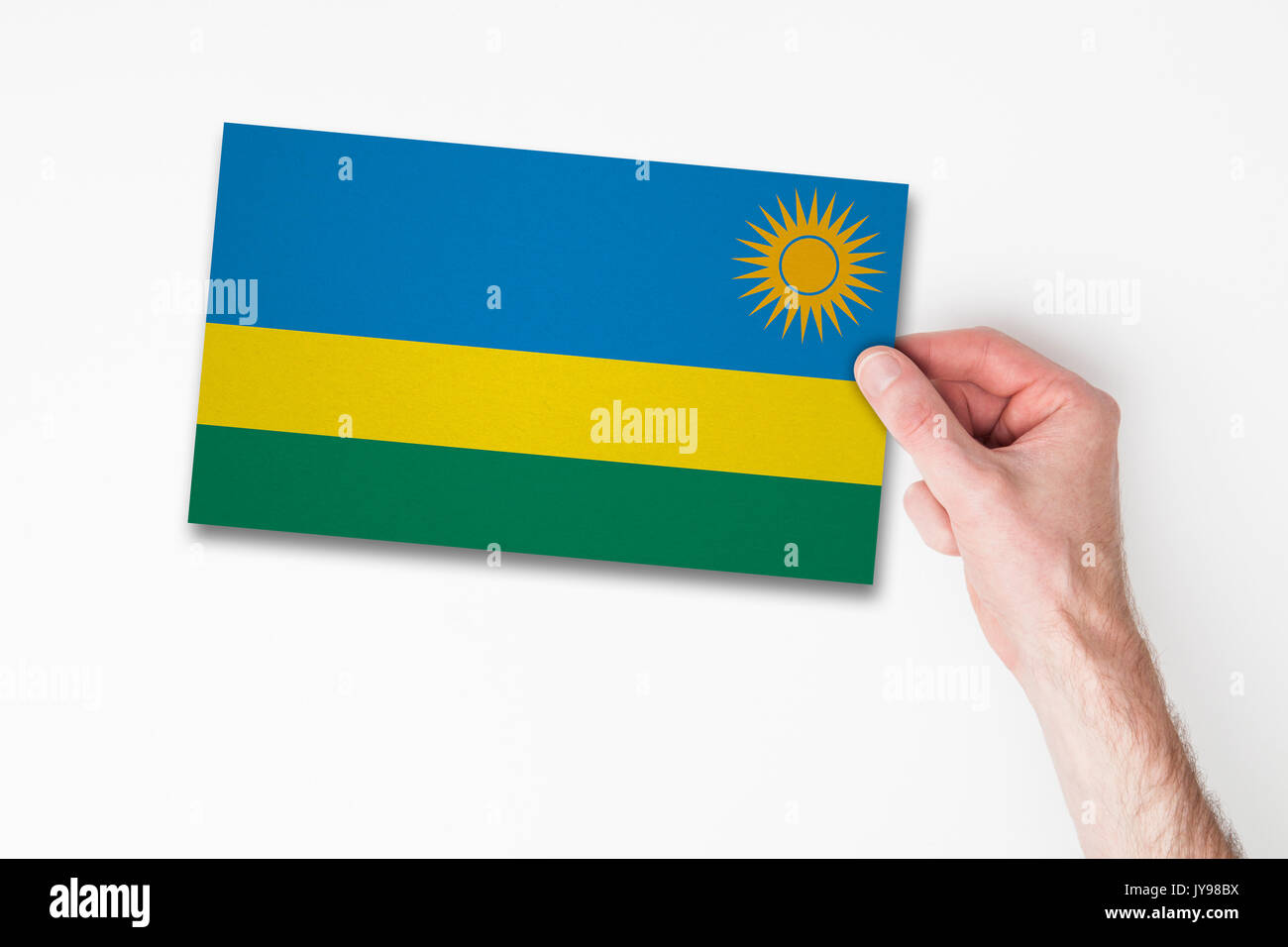 Male hand holding rwanda flag Stock Photo - Alamy