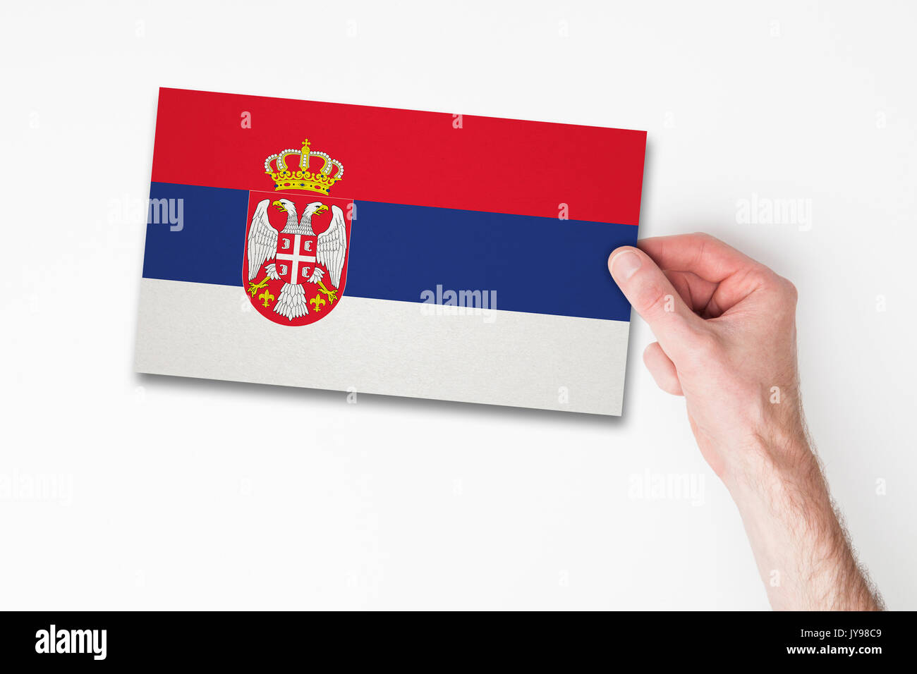 Male hand holding serbia flag Stock Photo - Alamy