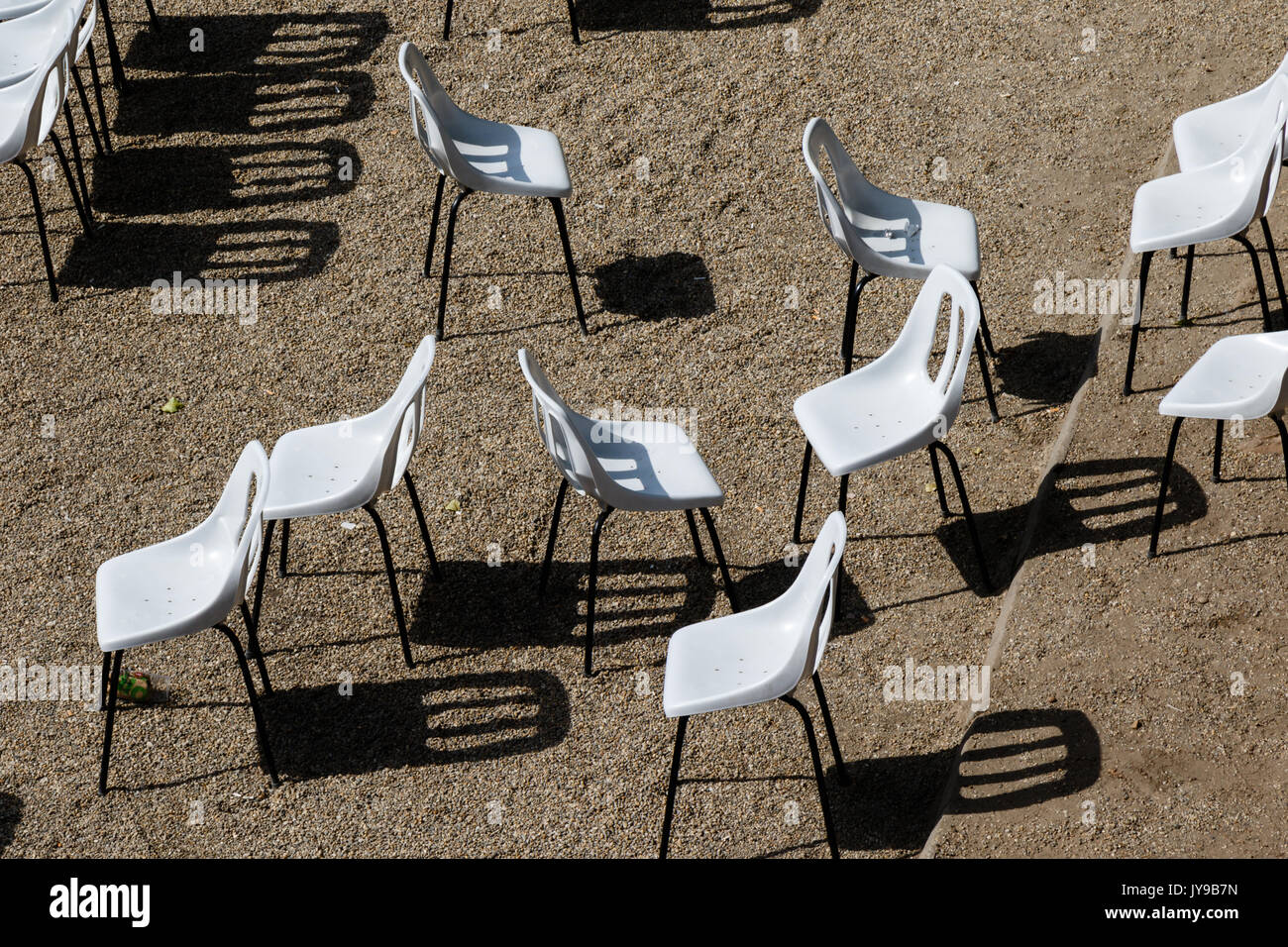 not arranged white empty plastic modern chairs Stock Photo - Alamy