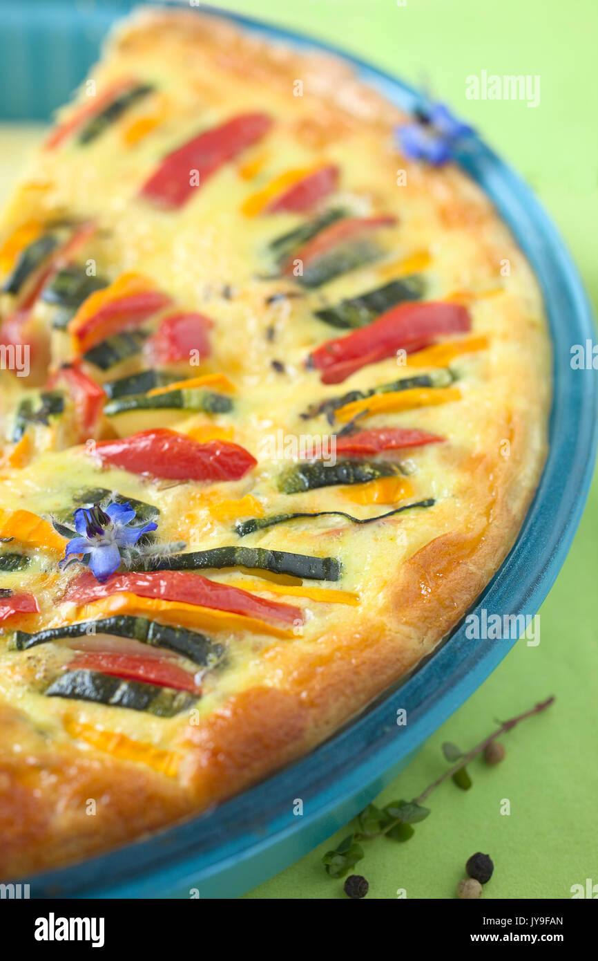 Quiche with tomato, green and yellow zucchini Stock Photo - Alamy