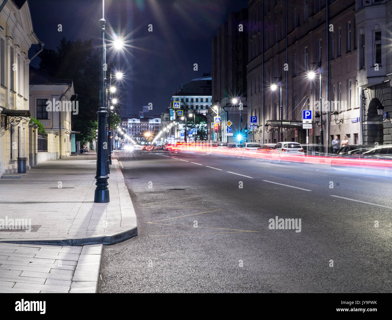 modern city street with lights and traffic at night. background ...