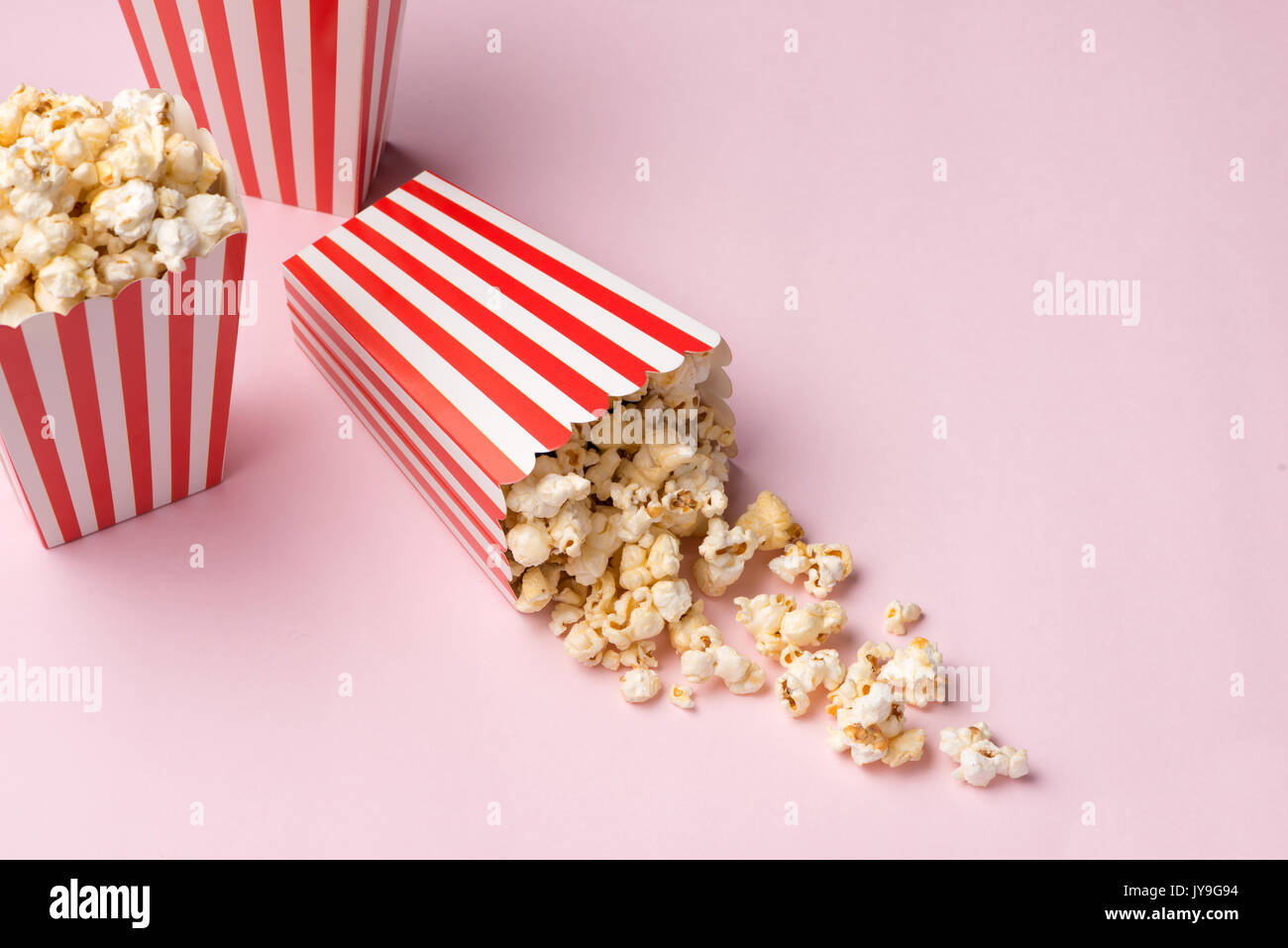 Popcorn in red and white cardboard box on the pink background Stock ...