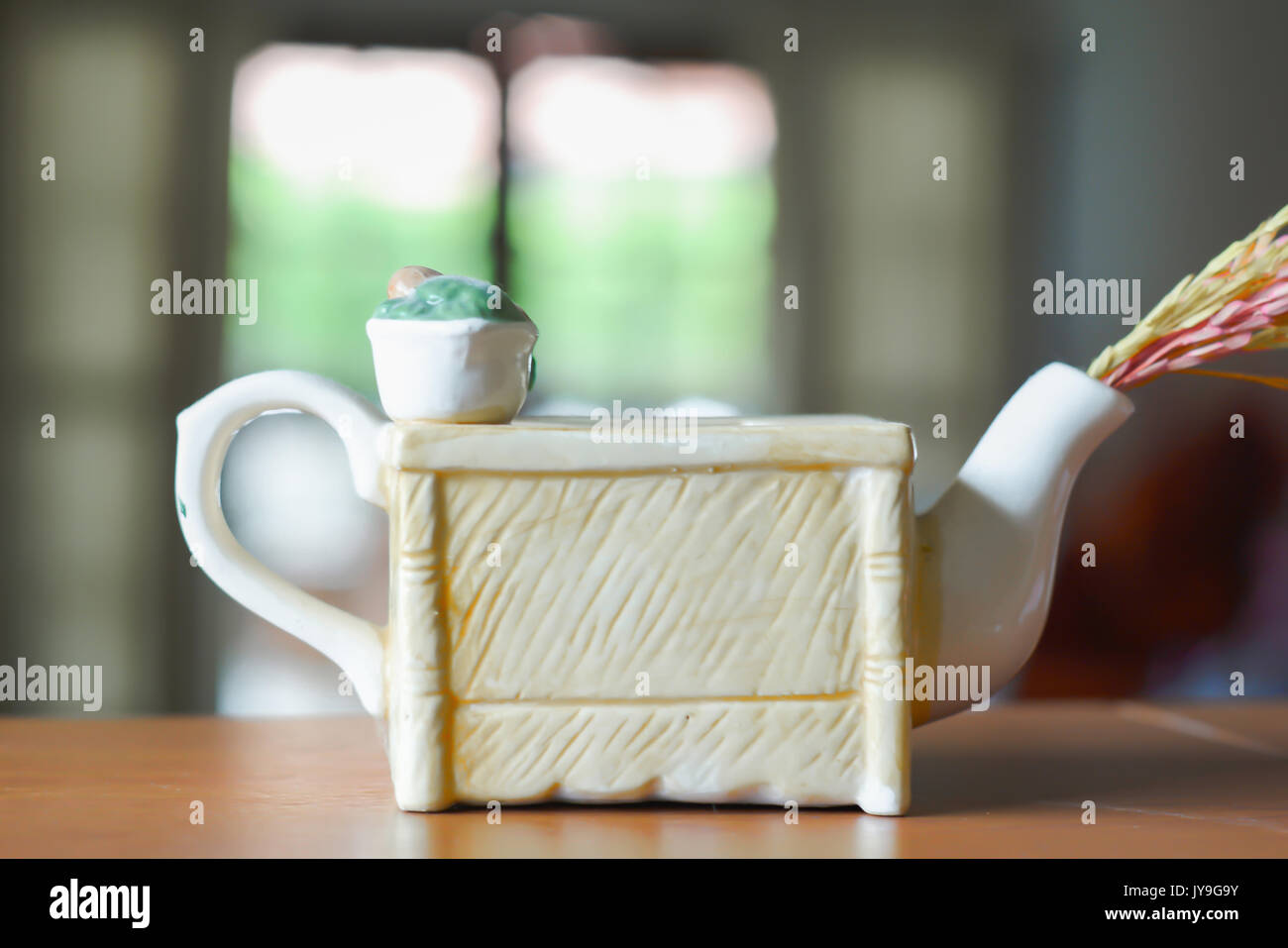 Decorative kettle on a wooden desk and living room background Stock ...