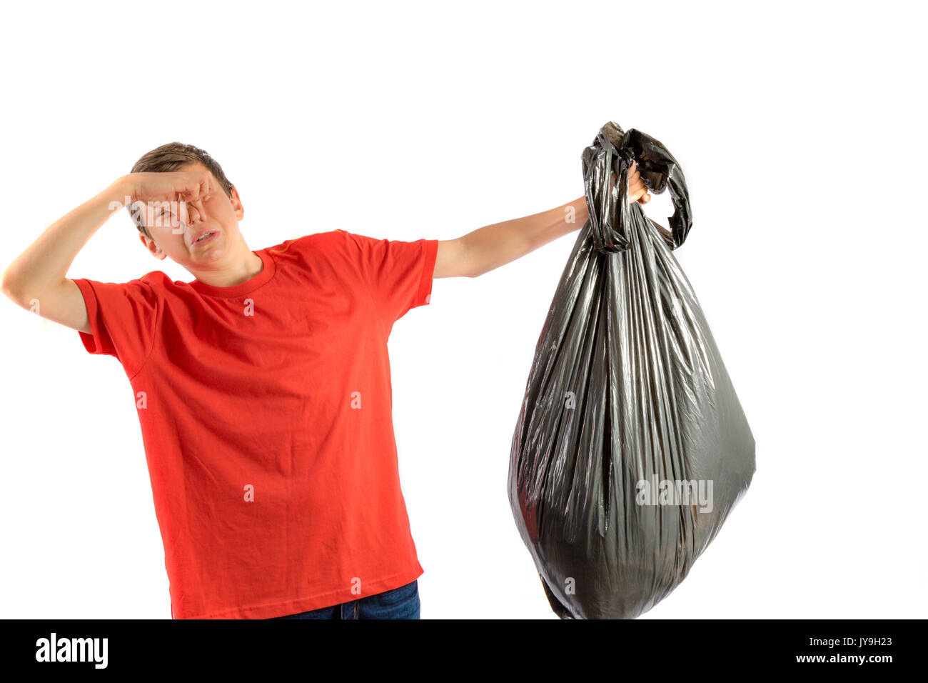 Young teenage boy isolated on a white background with smelly rubbish ...