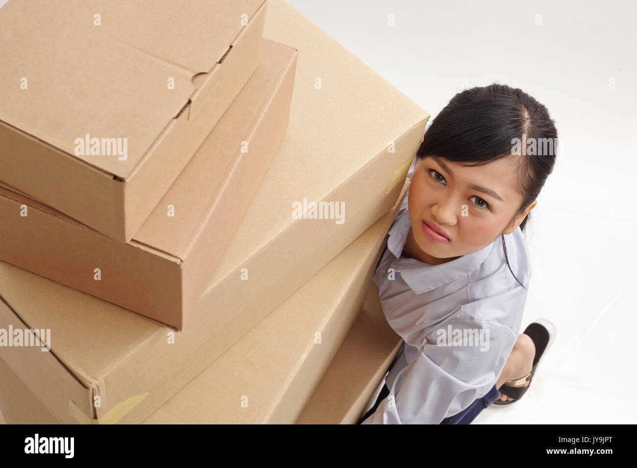 high angle view of asian woman lifting stack of boxes Stock Photo - Alamy