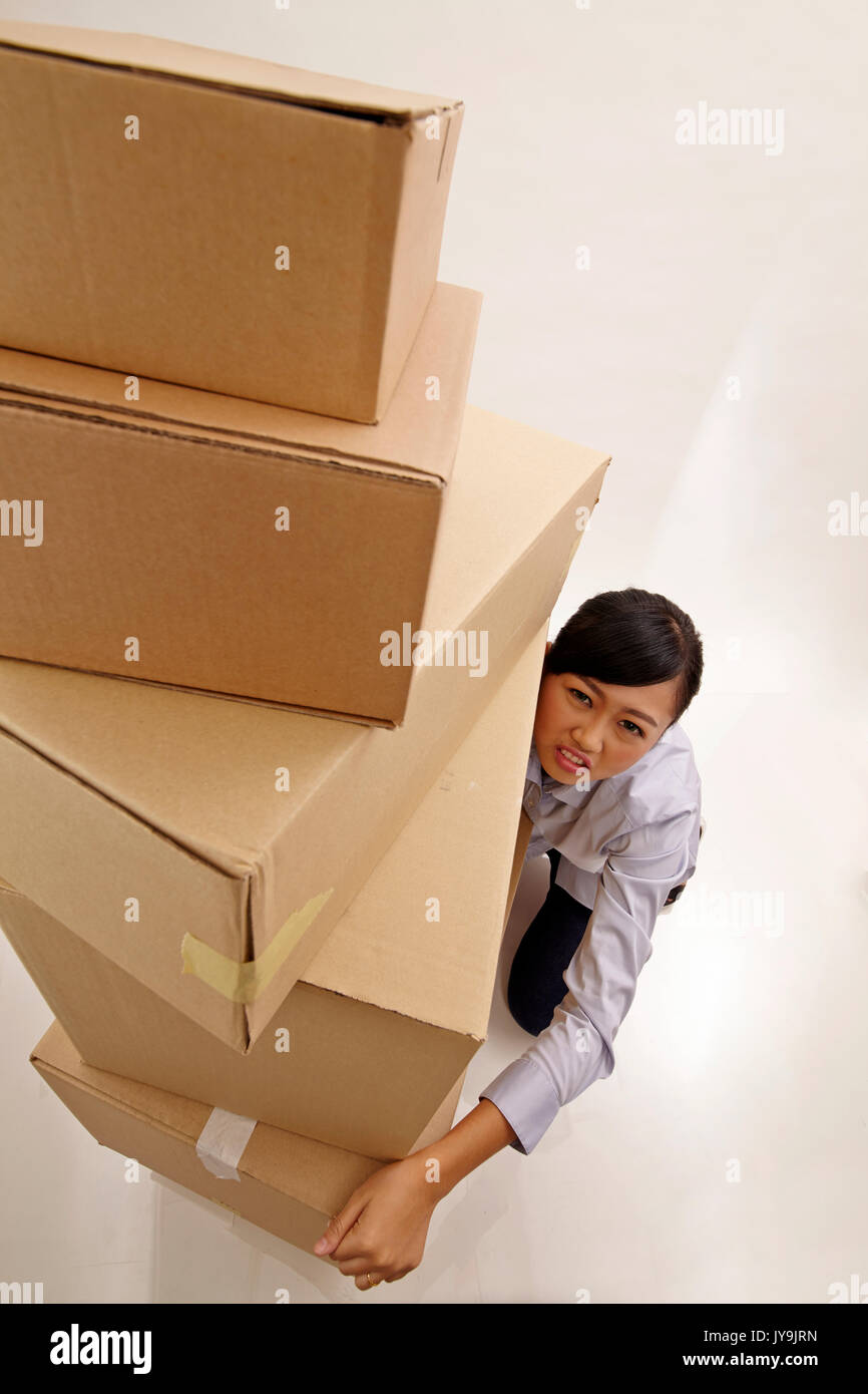 high angle view of asian woman lifting stack of boxes Stock Photo - Alamy
