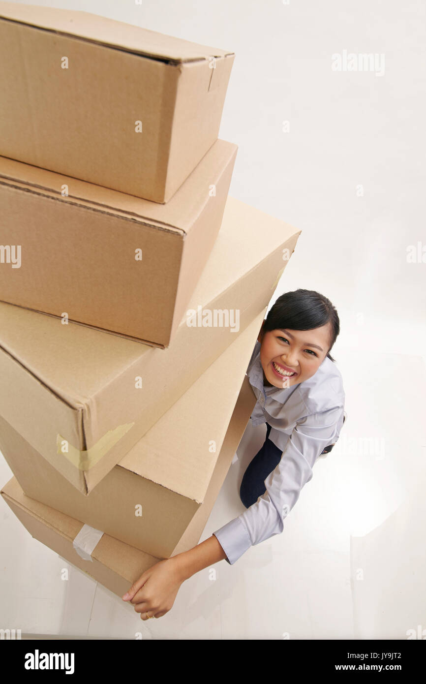 high angle view of asian woman lifting stack of boxes Stock Photo - Alamy