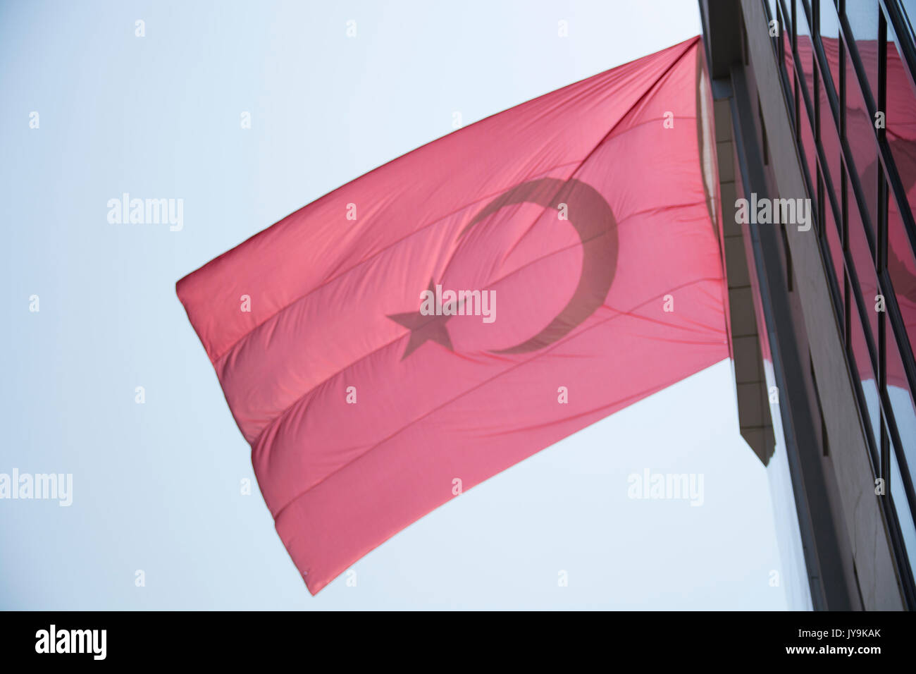 Turkish flag hanging on the top floor of the apartment Stock Photo - Alamy