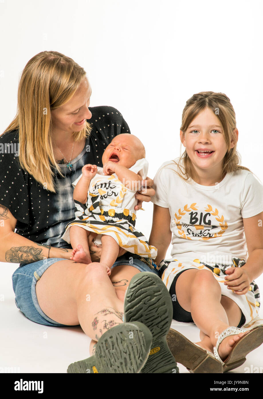 Studio portrait of mother, 7 year old daughter & 7 week old baby Stock ... Studio portrait of mother, 7 year old daughter & 7 week old baby Stock ...