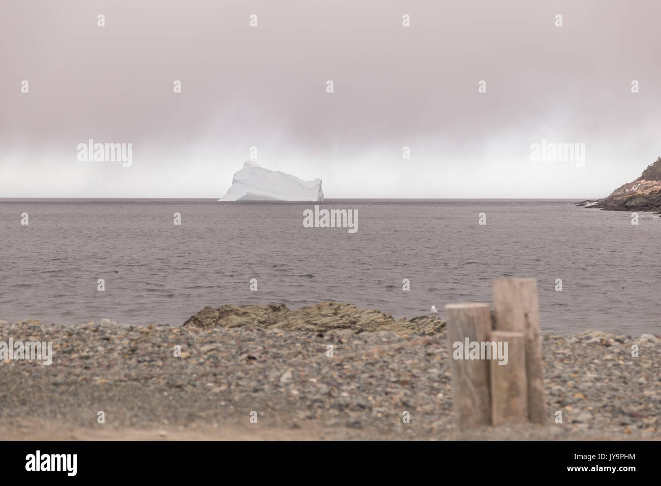 Large iceberg on the sea under storm clouds in Torbay, Newfoundland ...