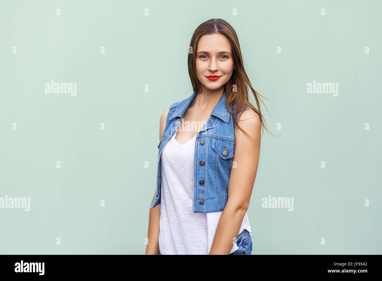 The tender and cute teenage female with shy faint smile, freckles and ...