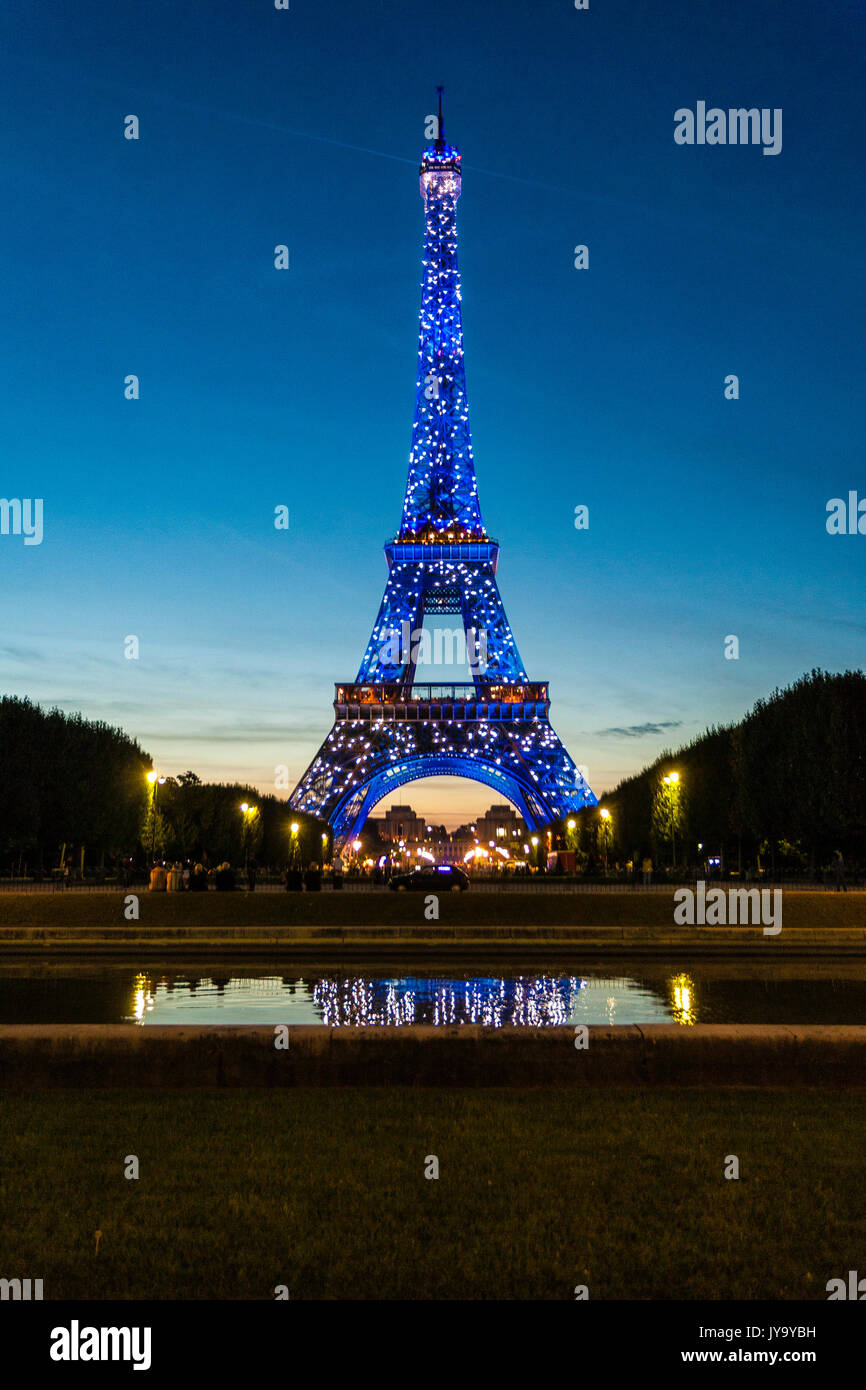 Colored lights illuminate the Eiffel Tower Champ de Mars Paris France ...