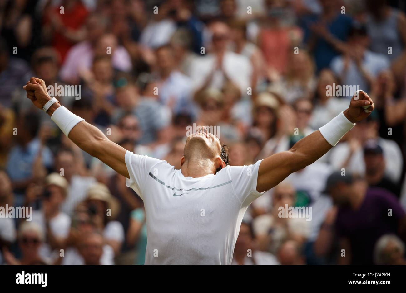 Rafael Nadal stretches his arms up and cheers after his victory in ...