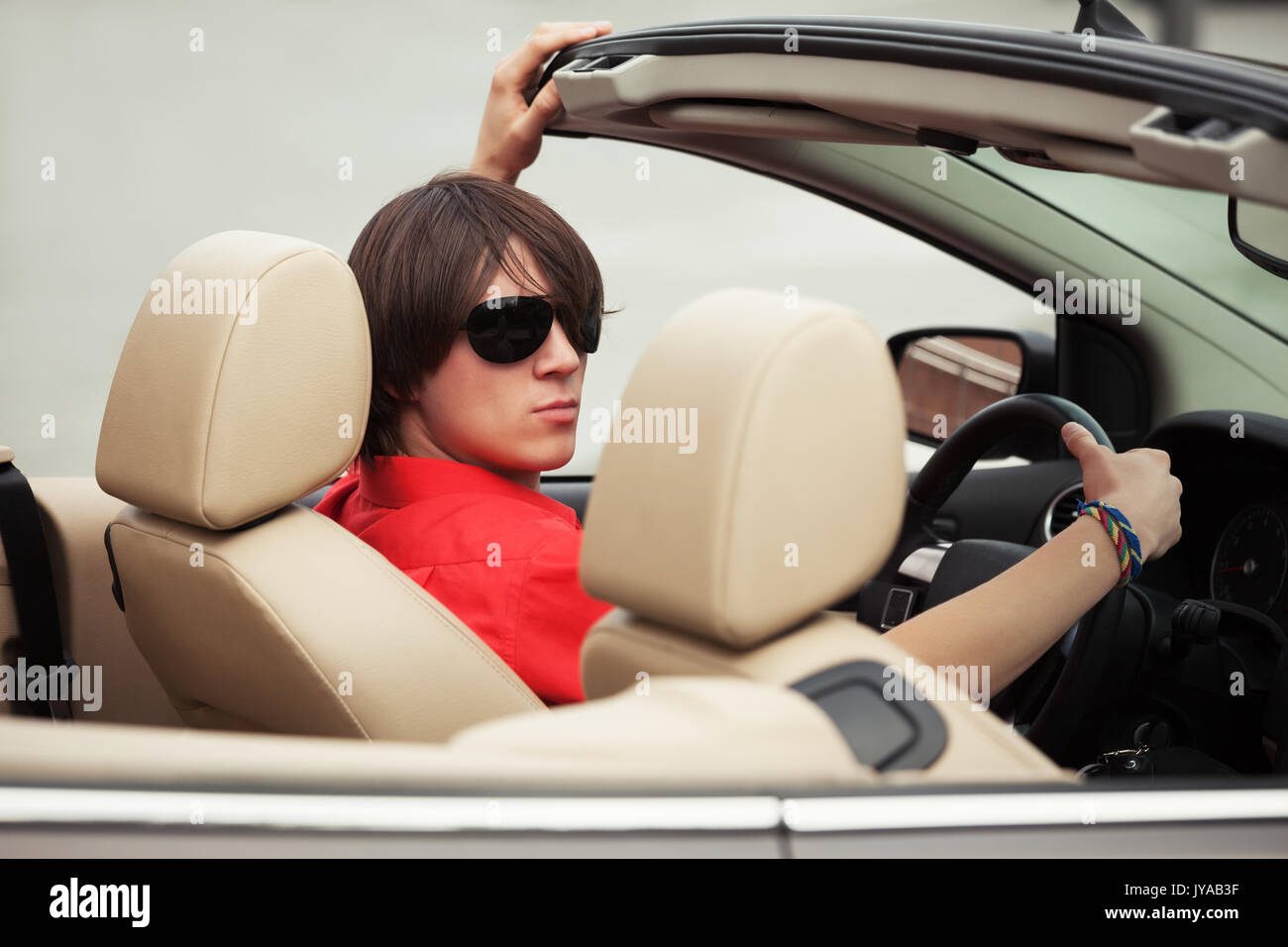 Cool guy driving convertible car hi-res stock photography and images ...