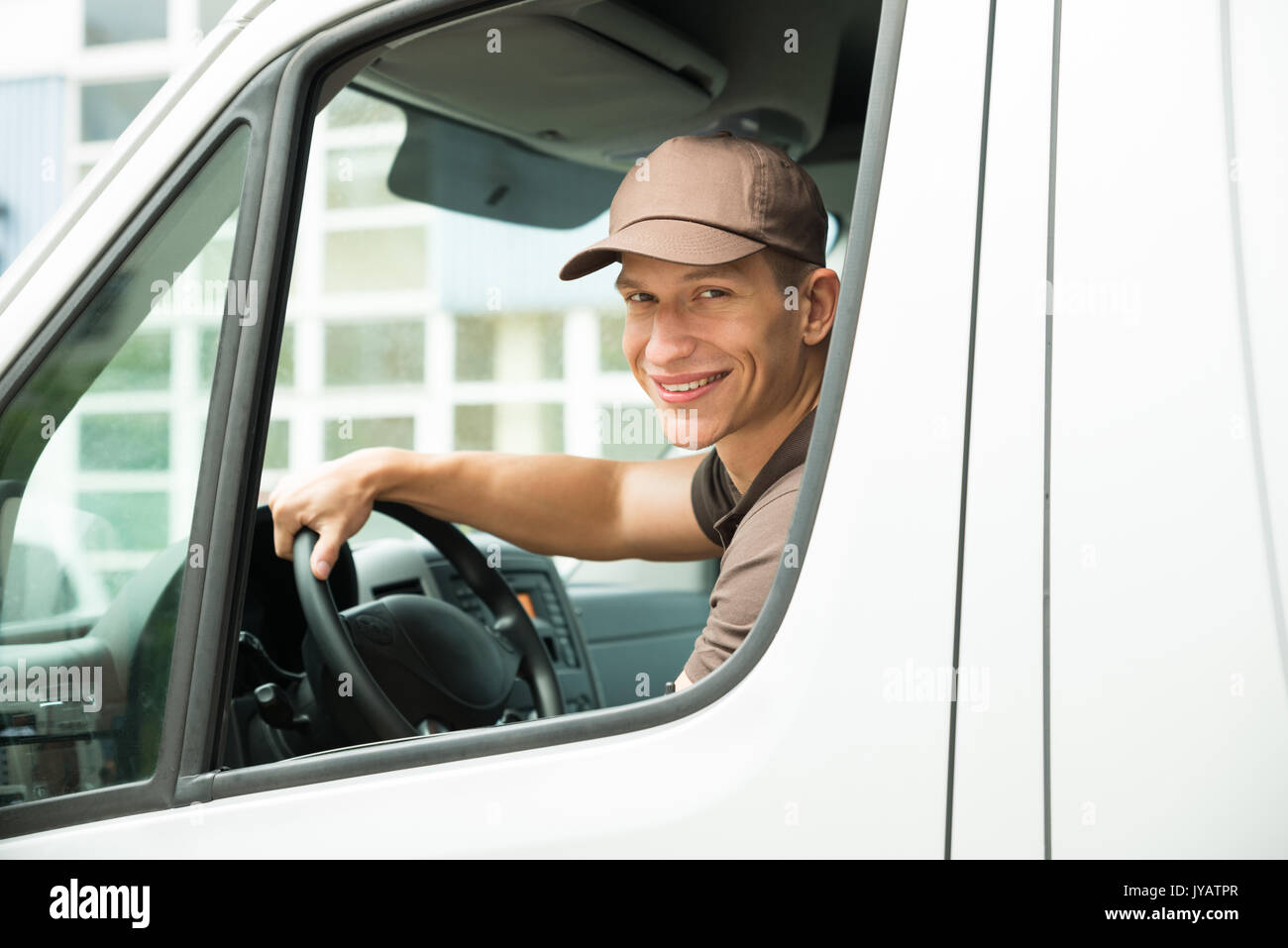 Young Happy Delivery Man Driving Service Delivery Van Stock Photo - Alamy