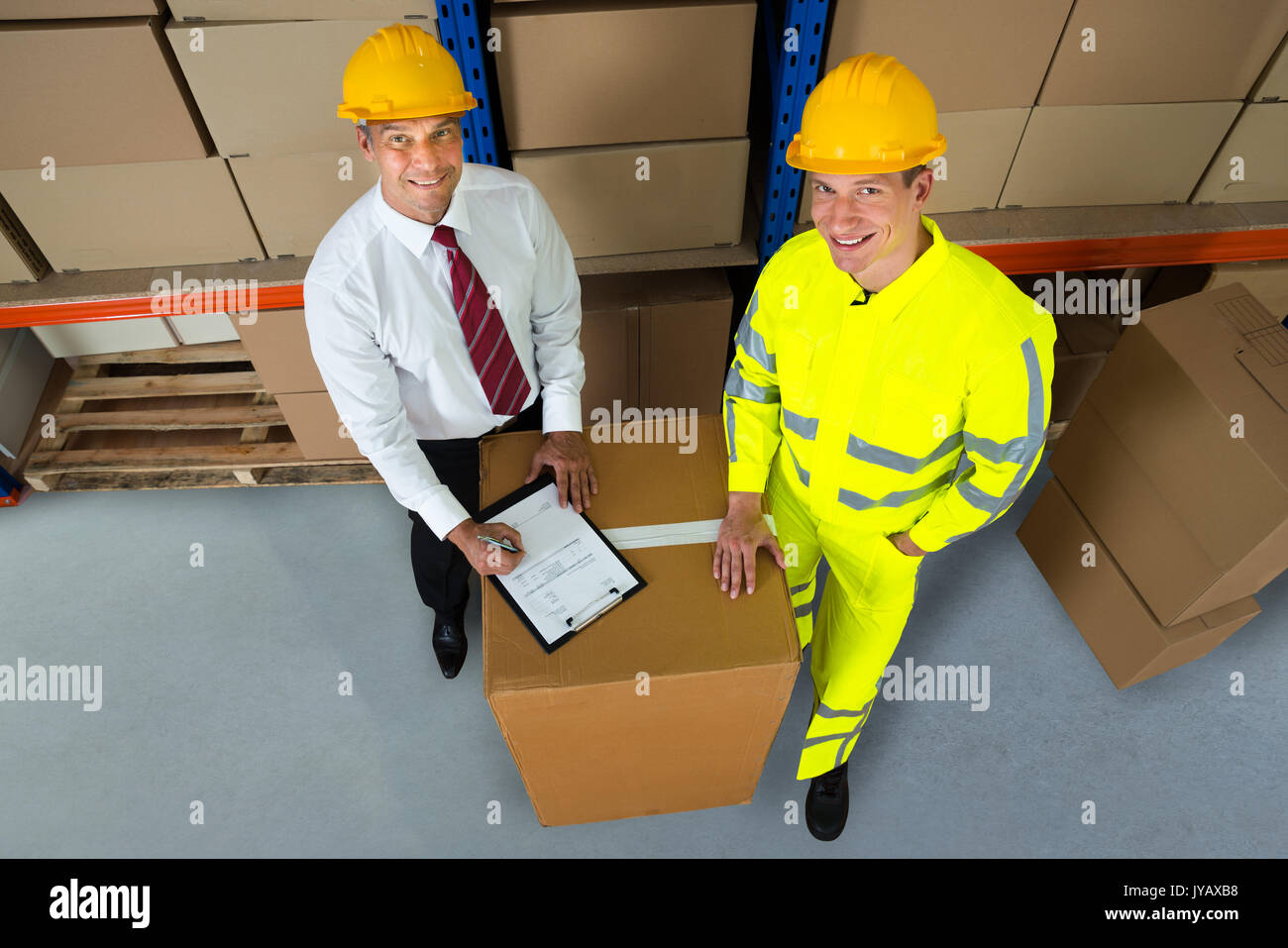 Happy Warehouse Worker And Manager Checking Inventory In Warehouse ...