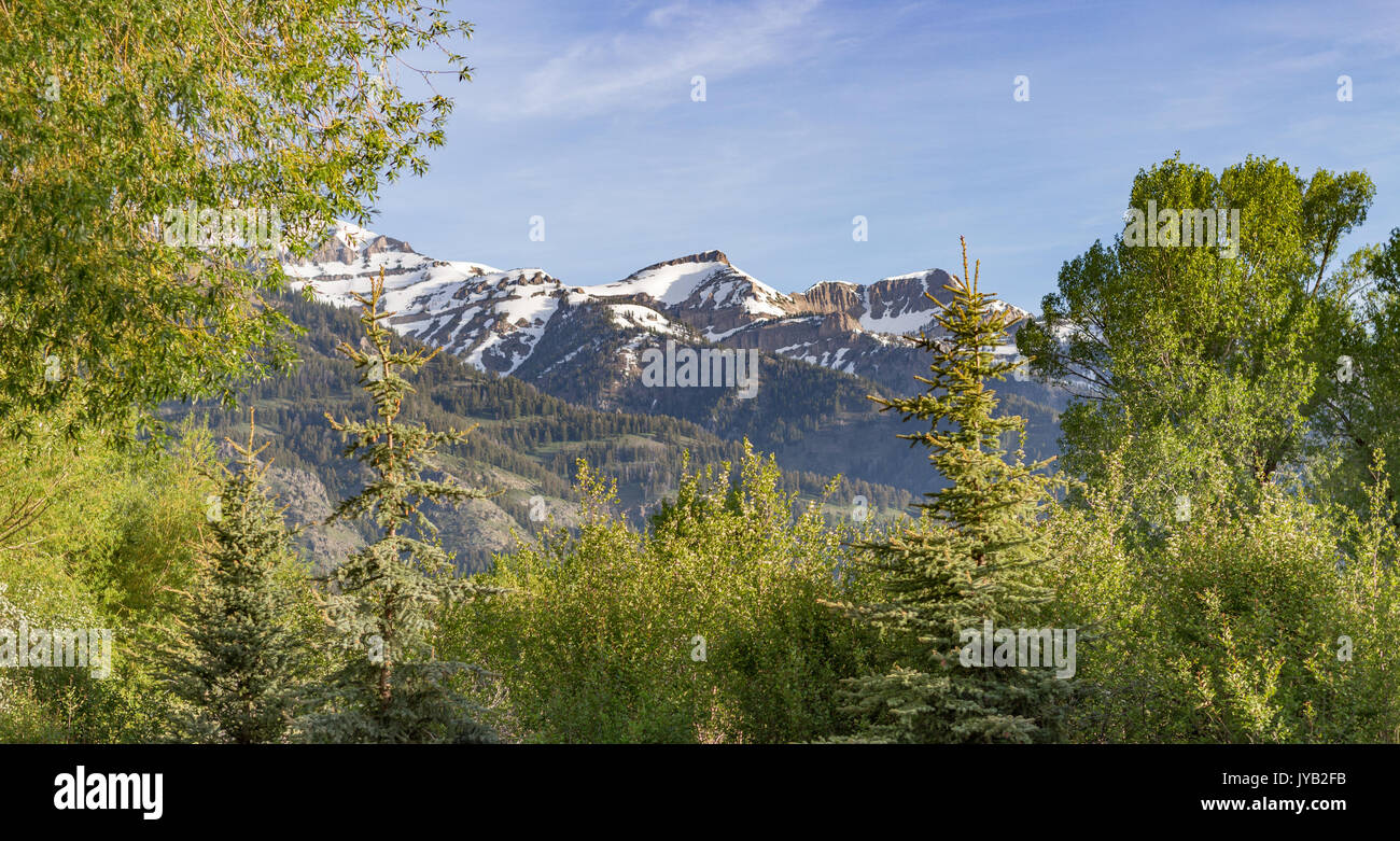 Snow-covered mountain-range landscape with split rail wooden fence ...