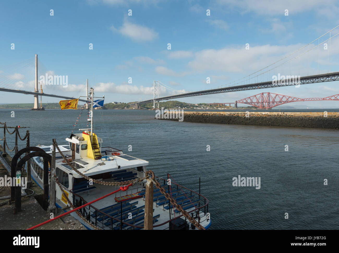 Forth river cruise boat at berth beside the three Forth bridges ...