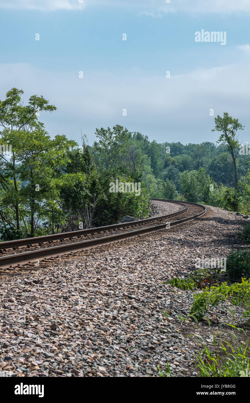 Railroad tracks on the edge of Lake Champlain with trees and crushed ...