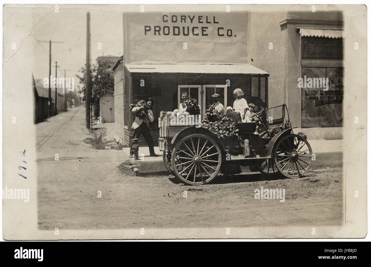 Men and children with automobile in front of Coryell Produce Co Stock ...