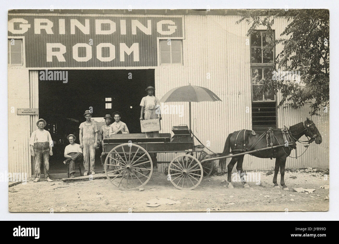 Men Standing in Front of Grinding Room Building Stock Photo - Alamy