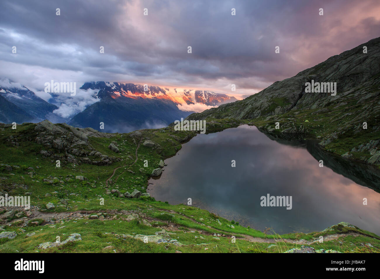 Clouds are tinged with purple at sunset at Lac de Cheserys Chamonix ...