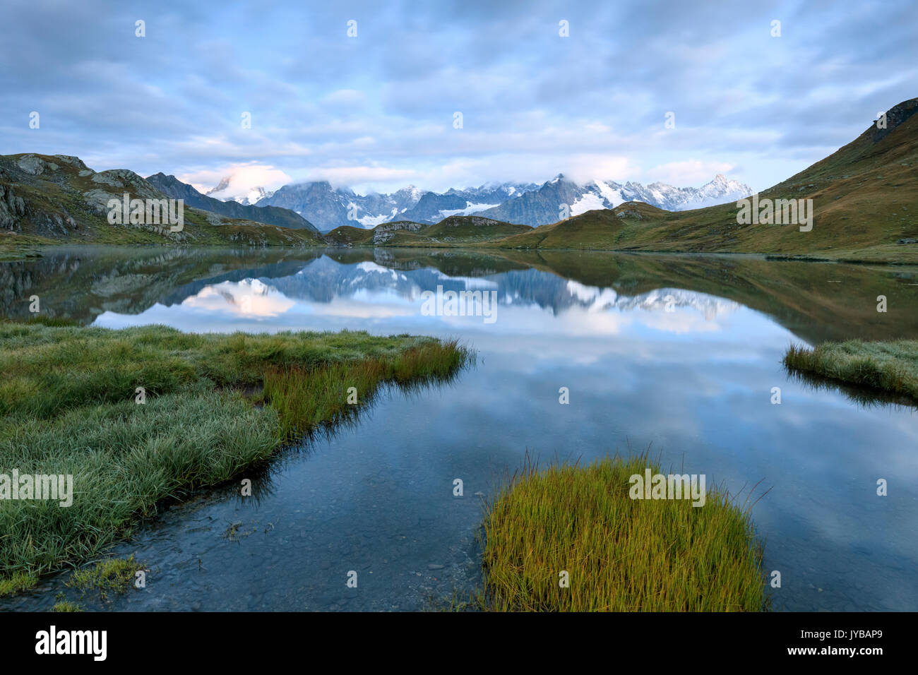 The mountain range is reflected in Fenetre Lakes at dusk Ferret Valley ...