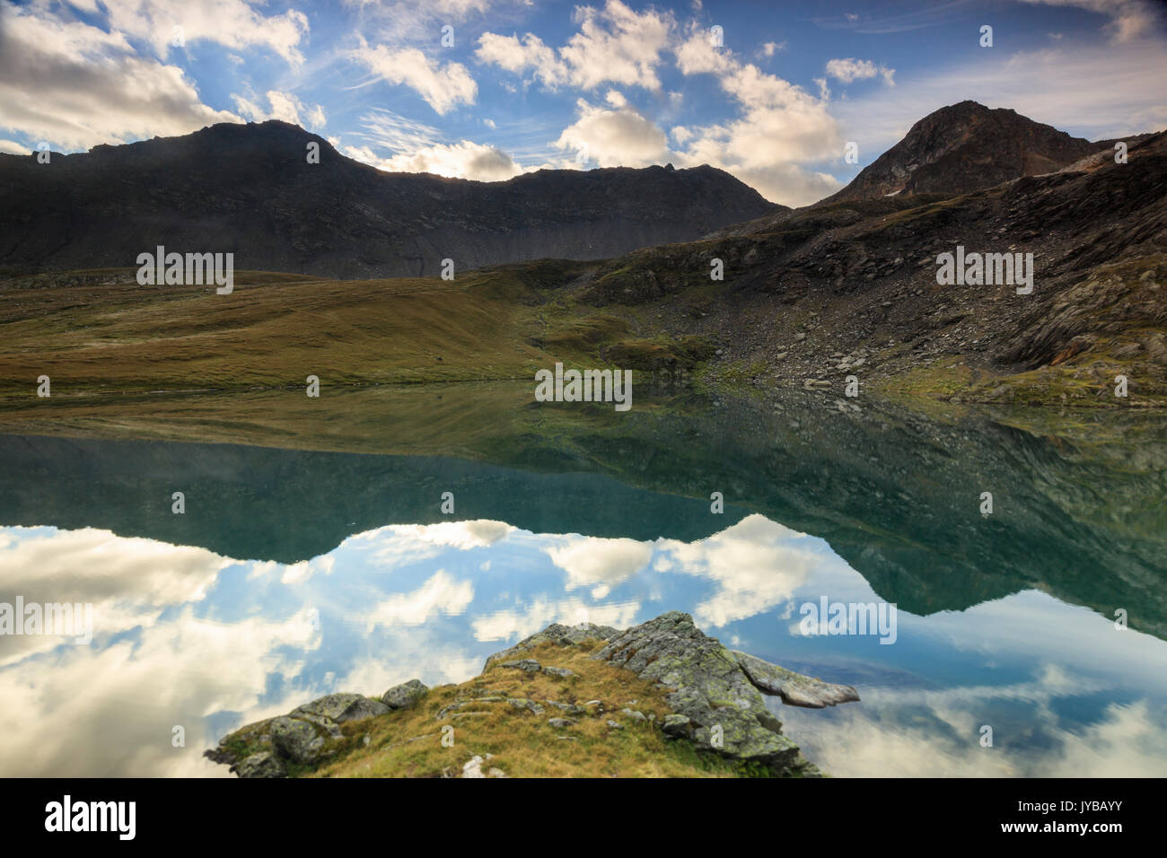 The high peaks and clouds are reflected in Fenetre Lakes Ferret Valley ...