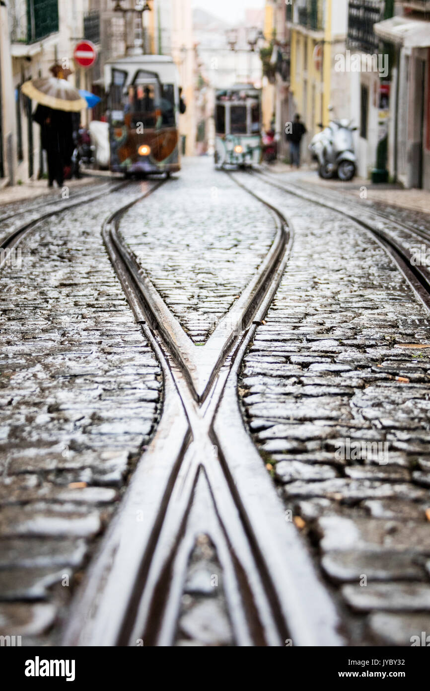 The steel rails on a rainy day with the typical trams leading to Bairro ...