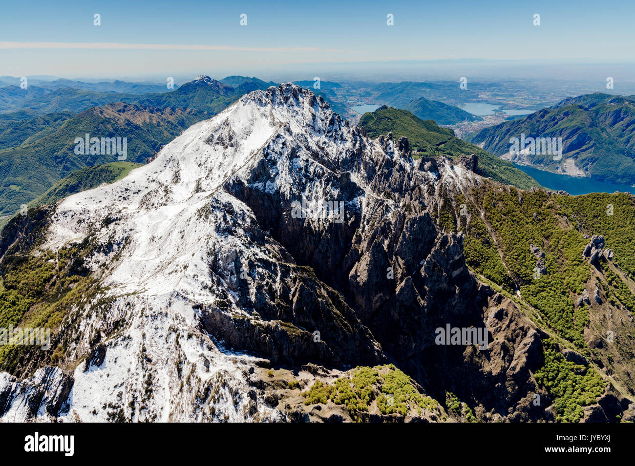 Aerial view of the snowy ridges of Grignetta and Resegone with the lake ...