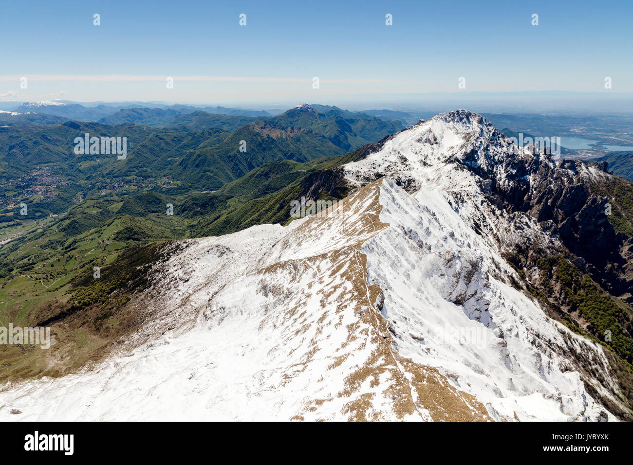 Aerial view of the snowy ridges of Grignetta and Resegone with the lake ...