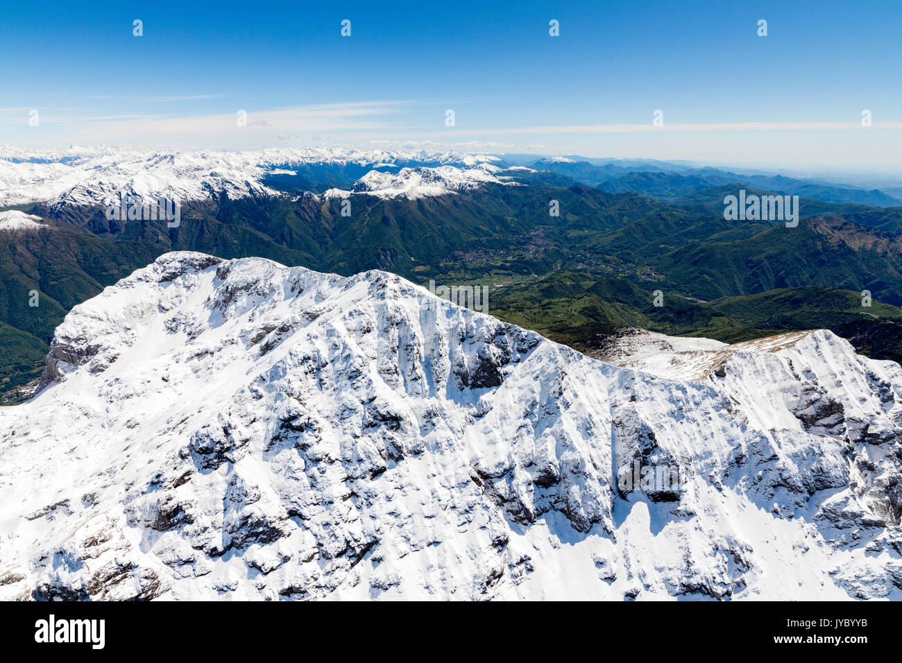 Aerial view of the snowy ridges of the Grignone mountain and Valsassina ...