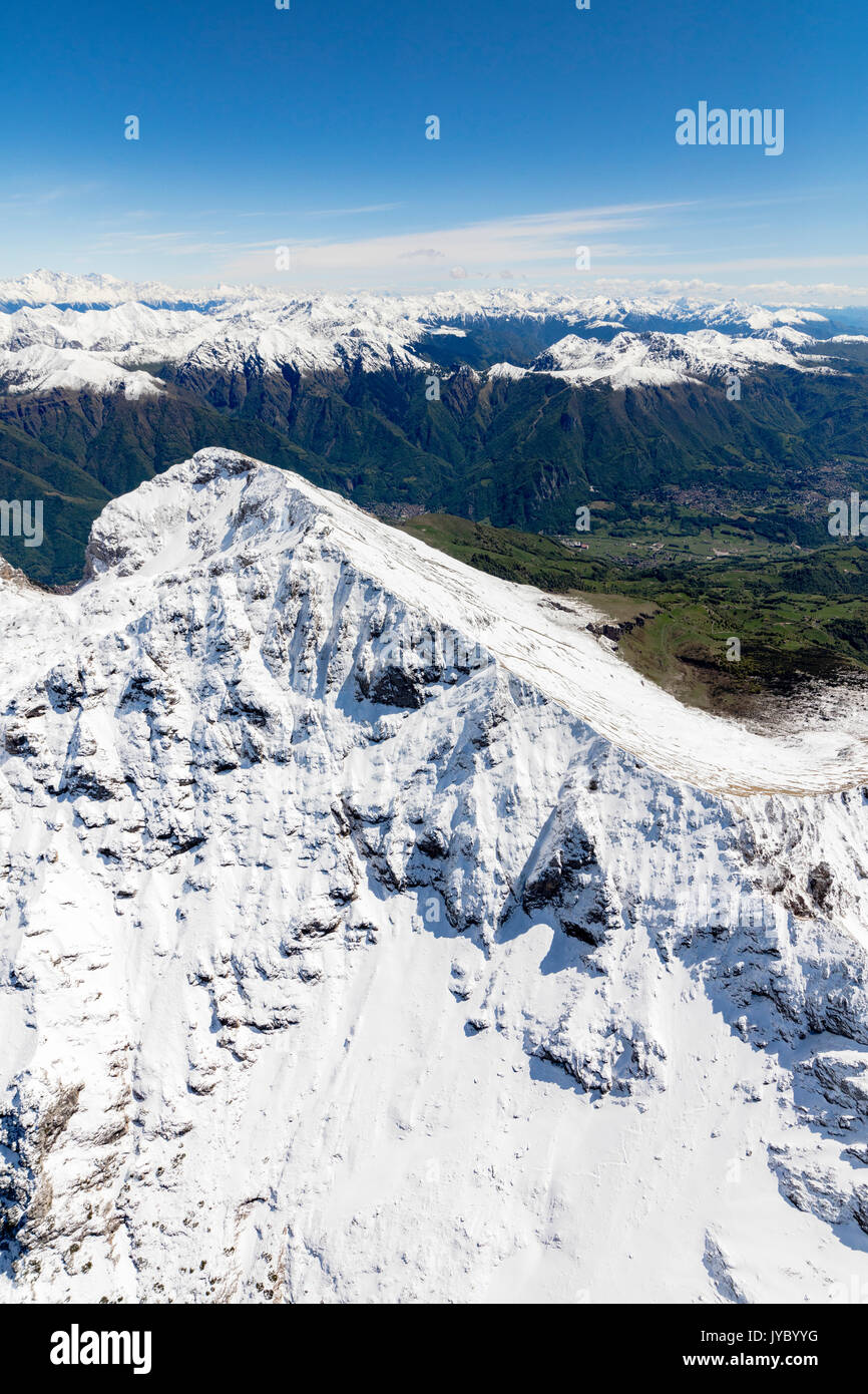 Aerial view of the snowy peaks of the Grignone mountain and Valsassina ...