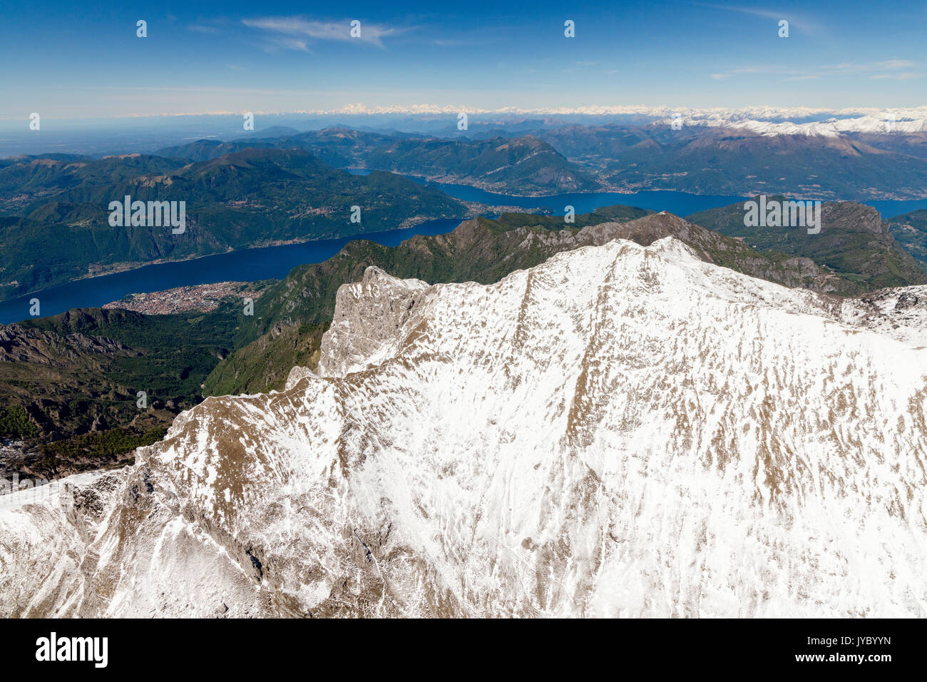 Aerial view of the snowy ridges of the Grignone mountain with Lake Como ...