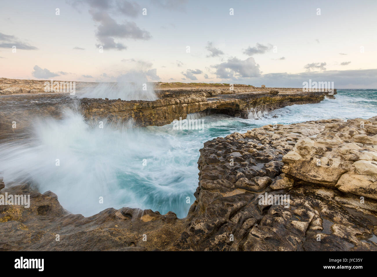 Waves of the rough sea crashing on the cliffs of Devil's Bridge ...